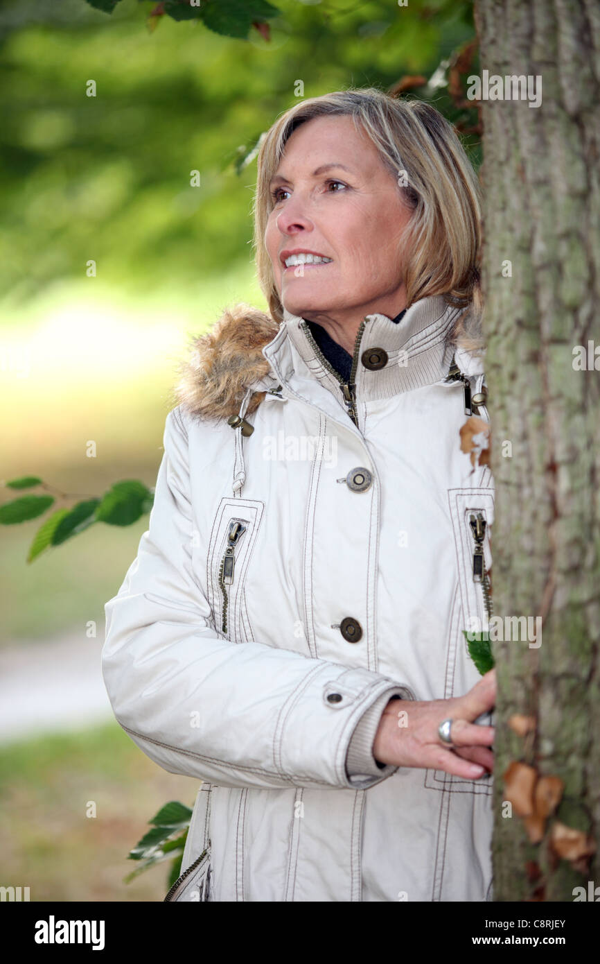 woman next to a tree Stock Photo - Alamy