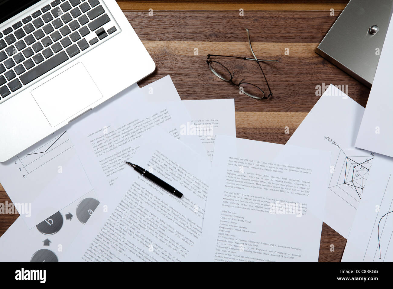 Laptop With Papers, Pen And Spec Stock Photo - Alamy