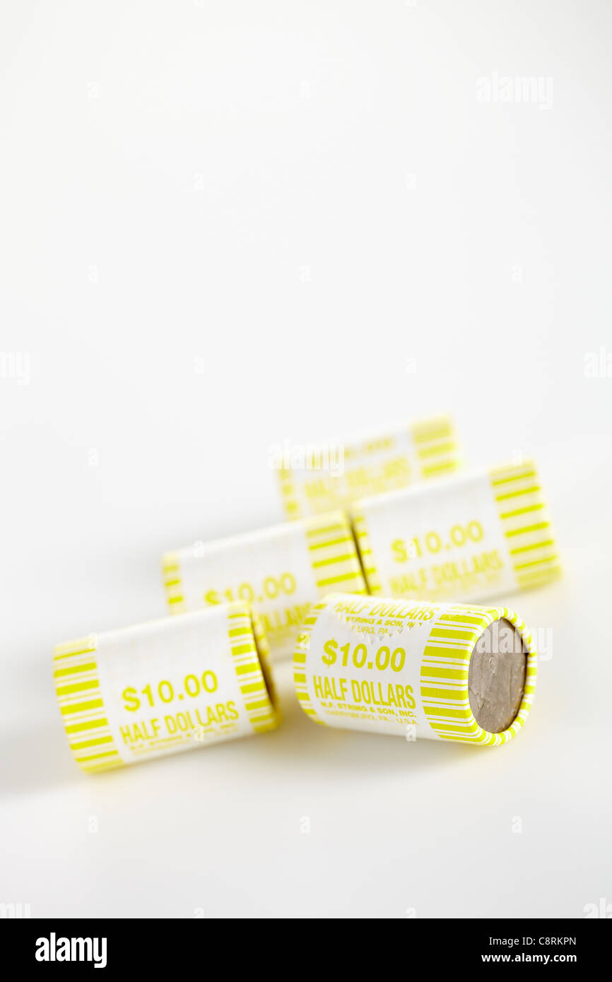 Rolls of coins against white background Stock Photo - Alamy