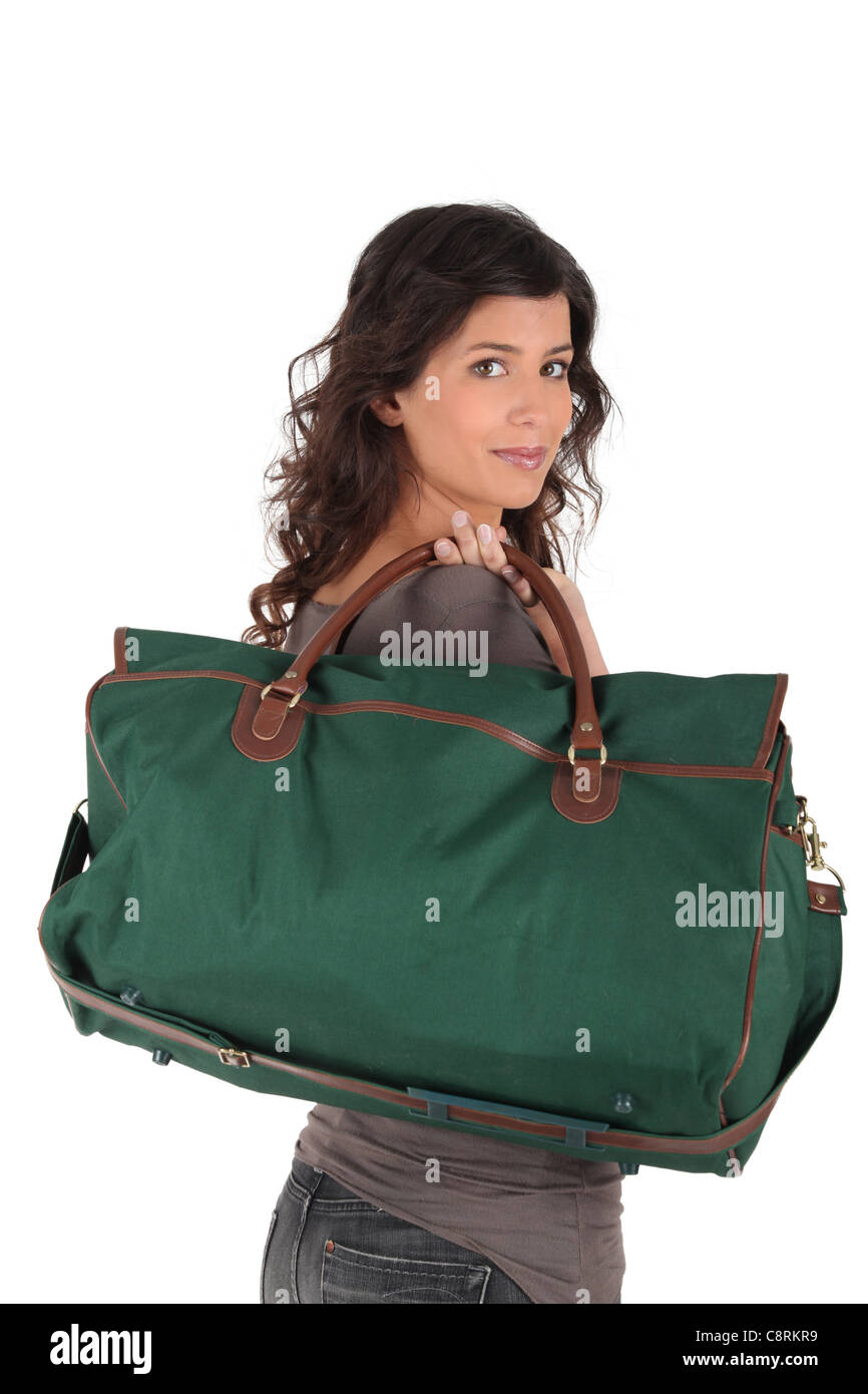 Woman carrying heavy travel bag Stock Photo - Alamy
