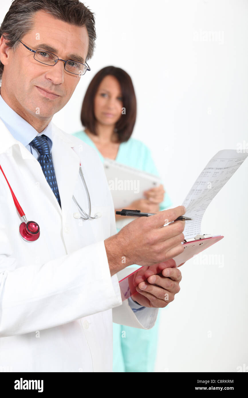 Doctor holding clipboard Stock Photo - Alamy