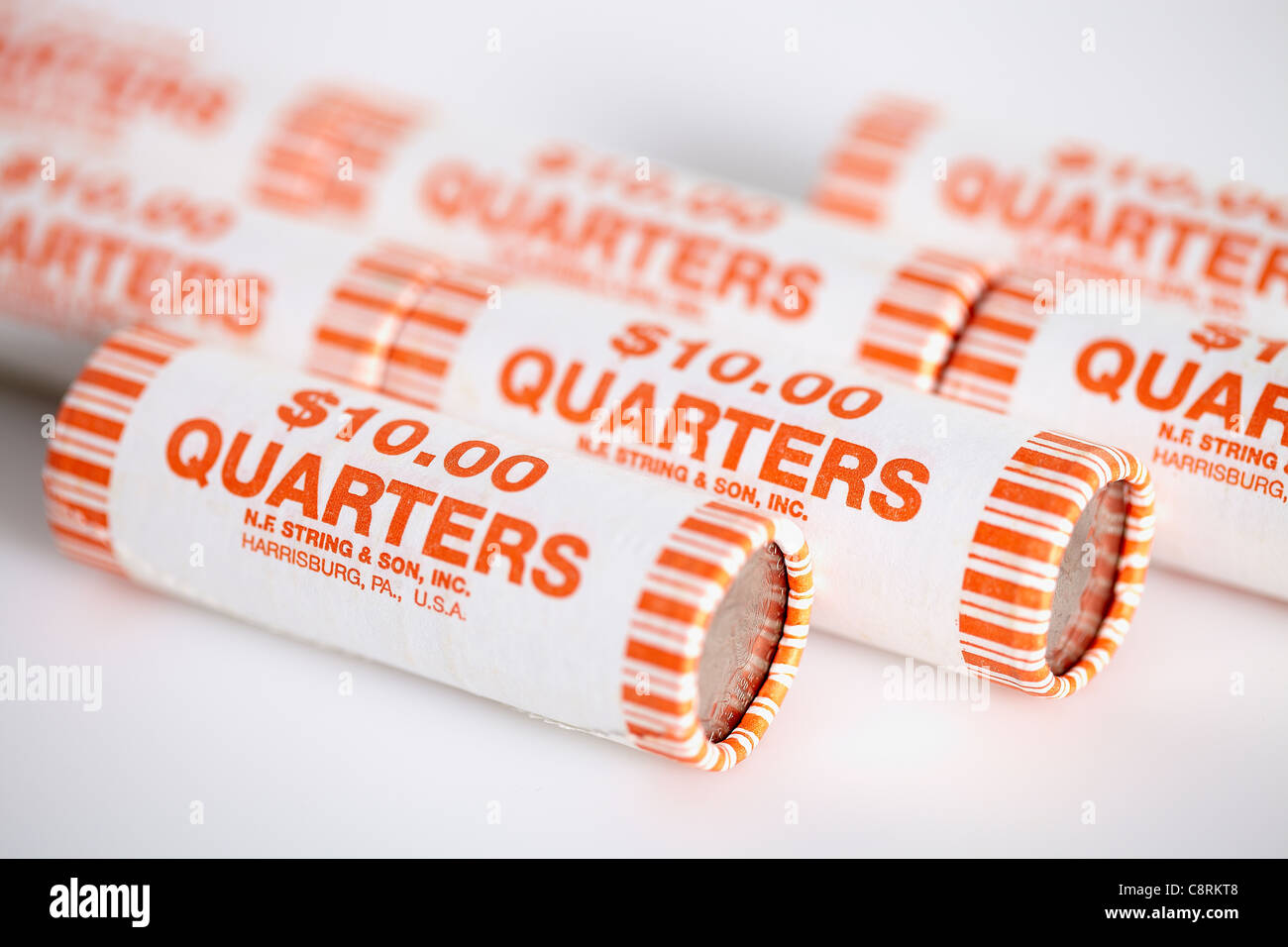 Close-up of roll of dollar coins Stock Photo - Alamy