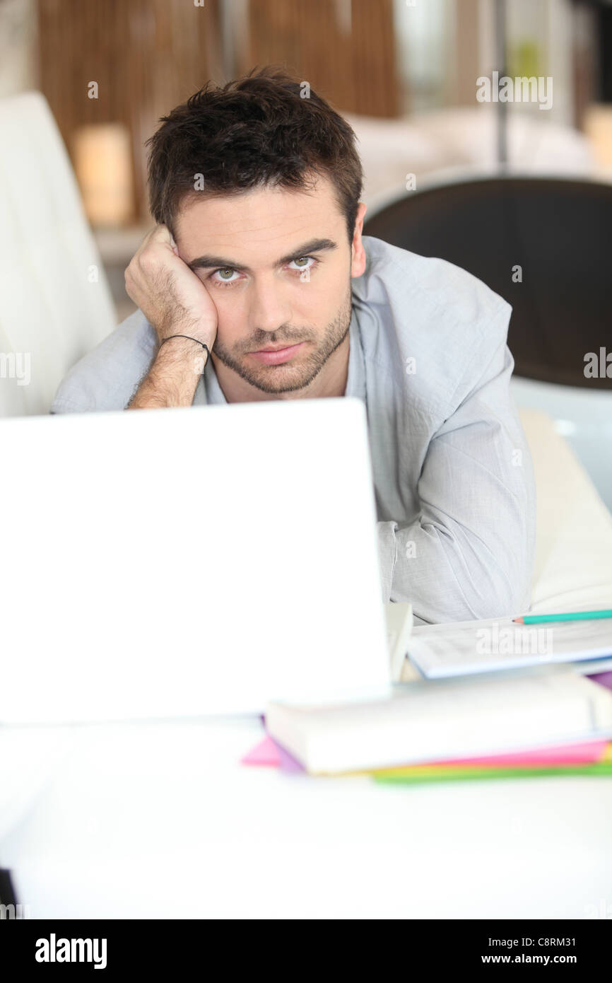 Bored man using laptop Stock Photo - Alamy Bored man using laptop Stock Photo - Alamy