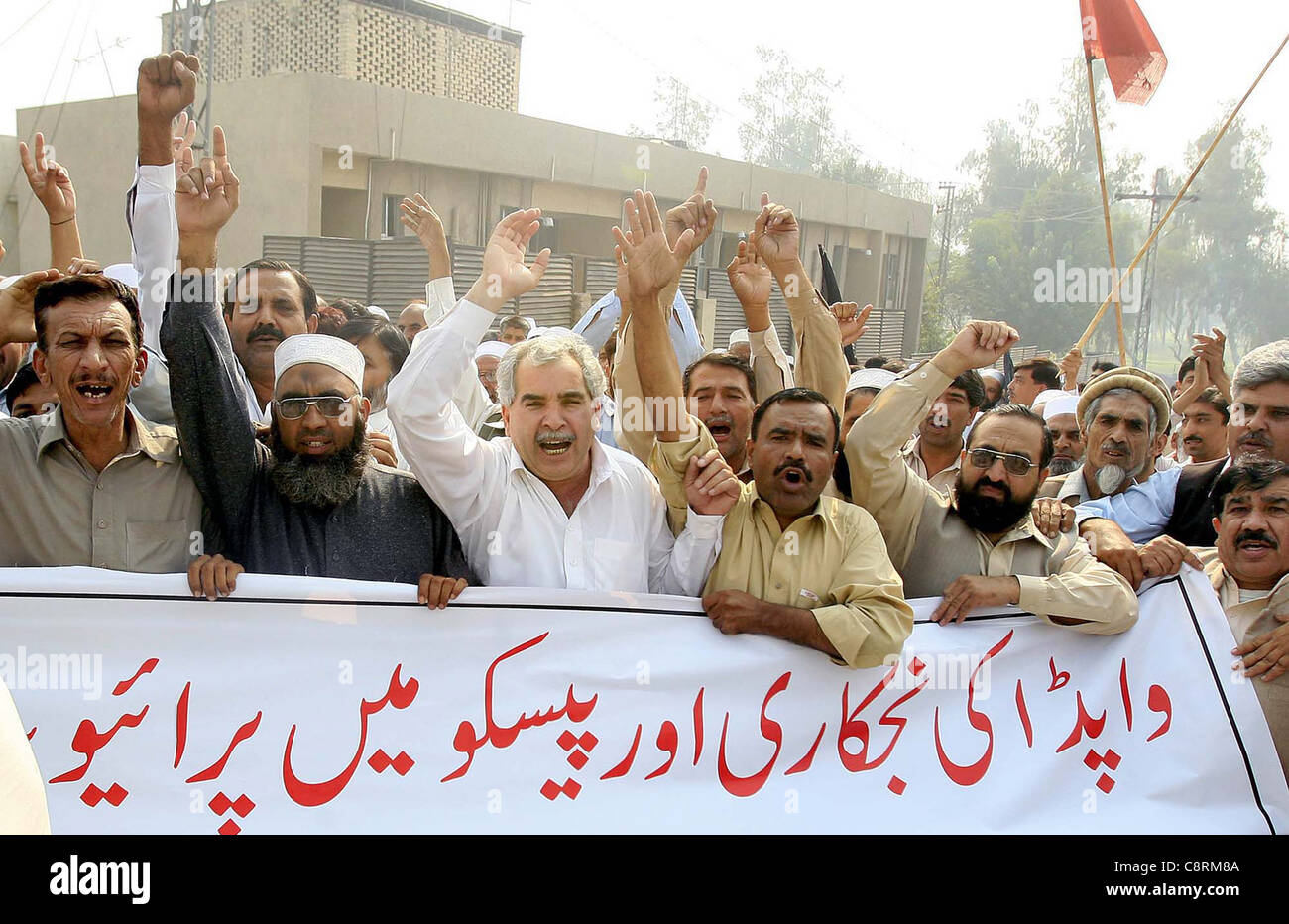 Supporters of WAPDA Hydro Electric Central Labor Union shout slogans in ...