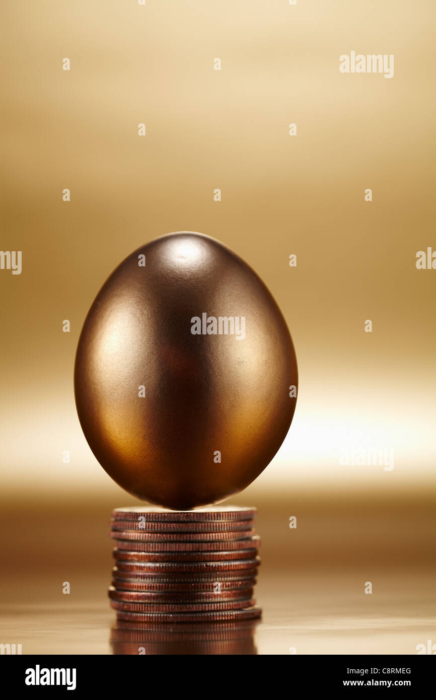 Golden egg stack coin hi-res stock photography and images - Alamy