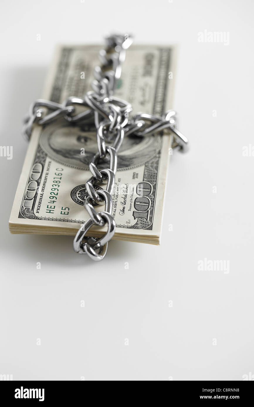 Bundle of American currency notes tied with metal chain Stock Photo - Alamy