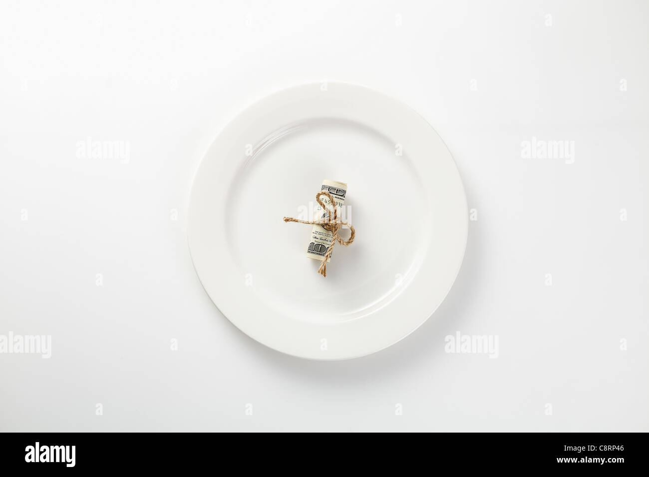 Stack of money tied with rope and kept on plate Stock Photo - Alamy