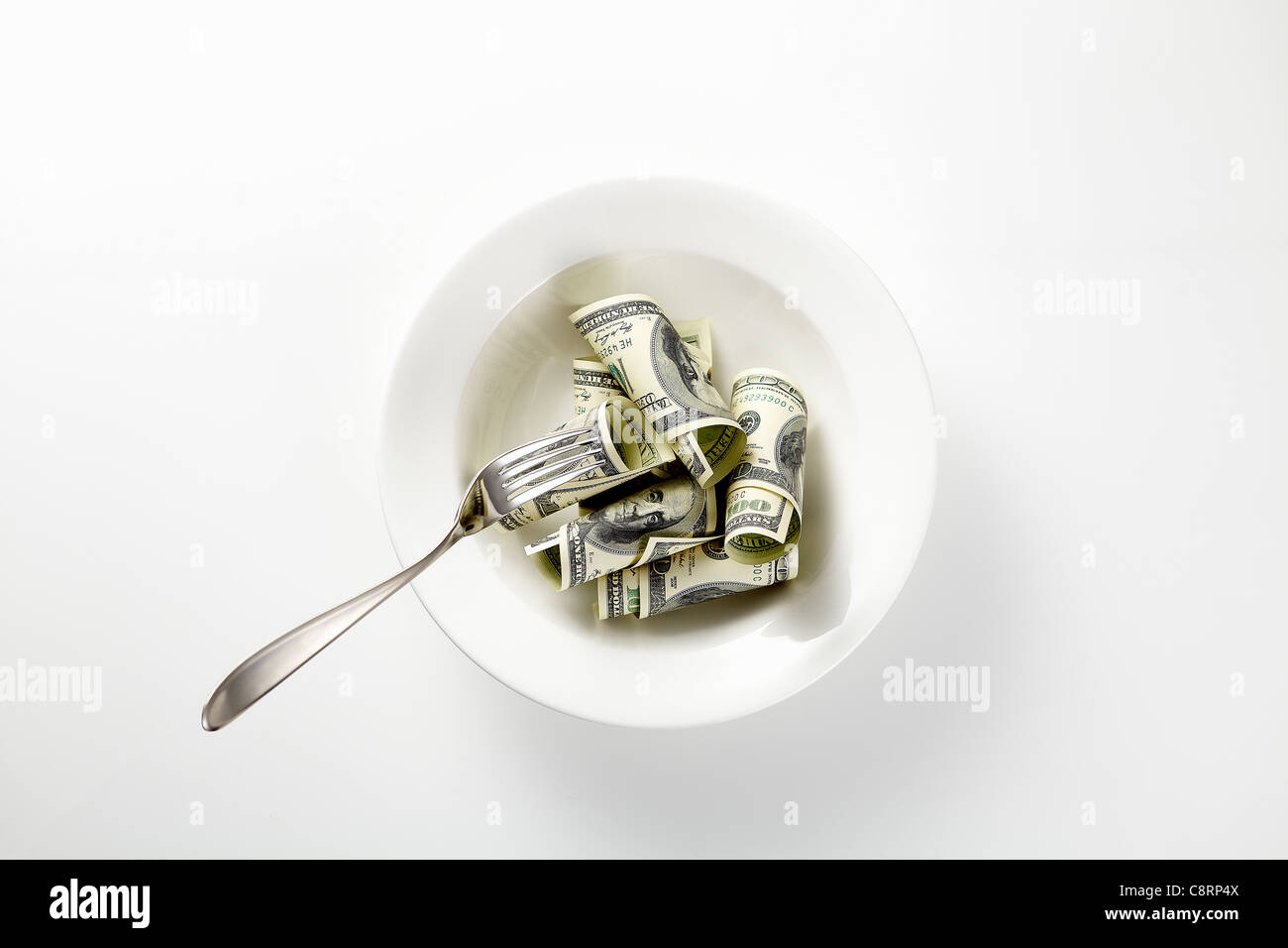 American currency notes on plate with fork Stock Photo - Alamy