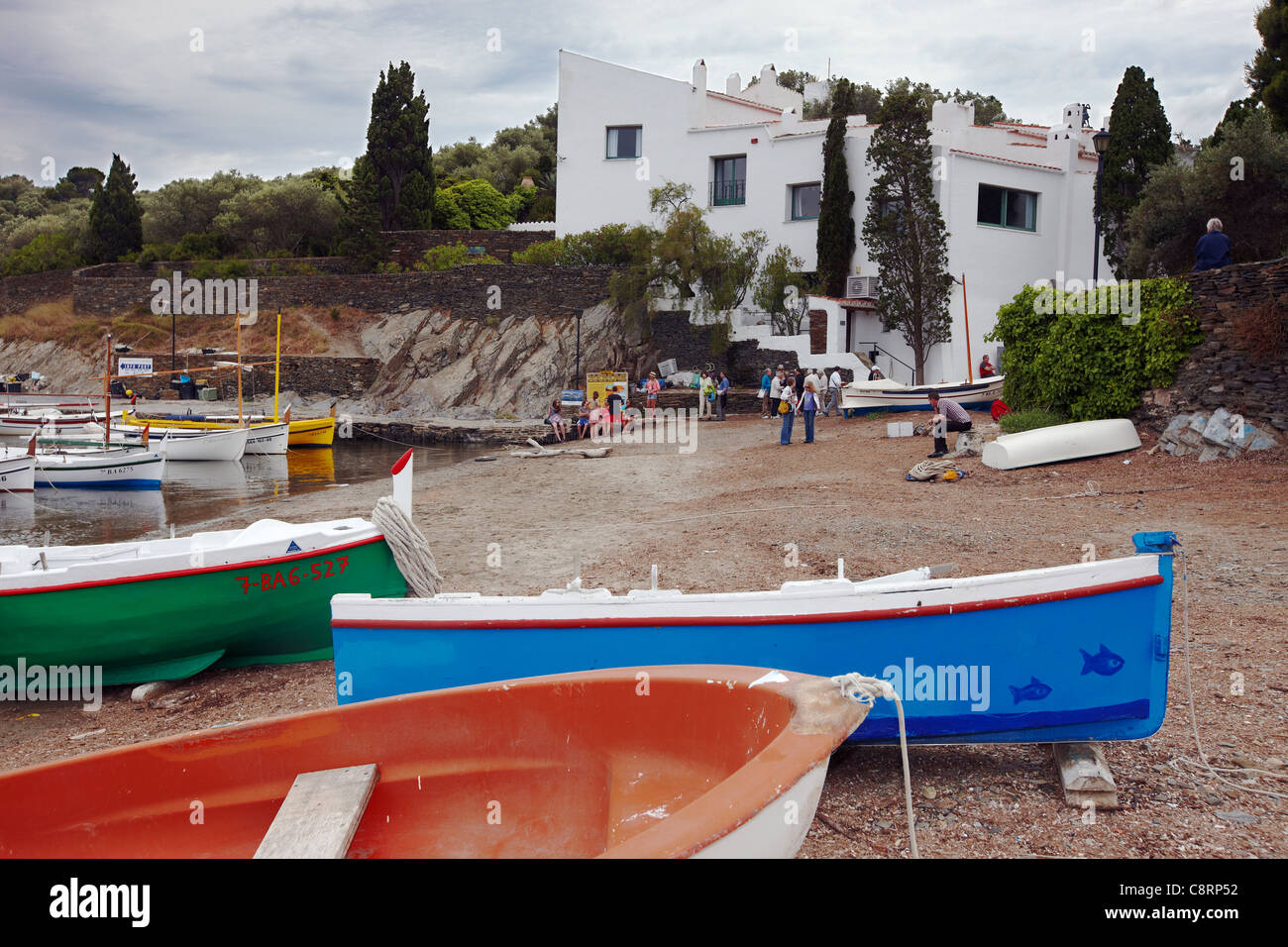 Colorful boats on the beach in front of Salvador Dali House-Museum in ...