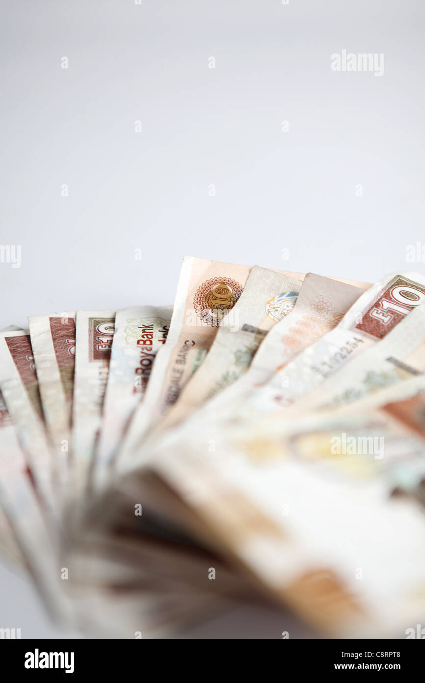 Ten pound notes spread out on a white background Stock Photo - Alamy