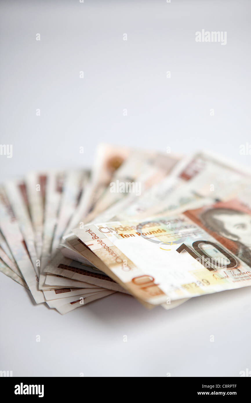 Ten pound notes spread out on a white background Stock Photo - Alamy