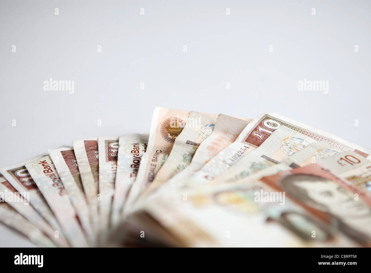 Ten pound notes spread out on a white background Stock Photo - Alamy