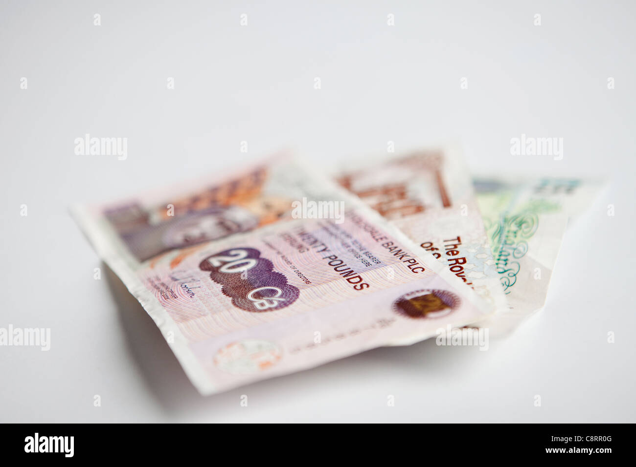 Three money notes against a plain white background Stock Photo - Alamy