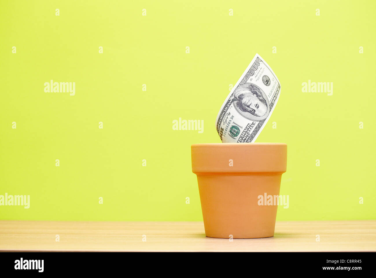One hundred dollar bill growing on flower pot Stock Photo - Alamy
