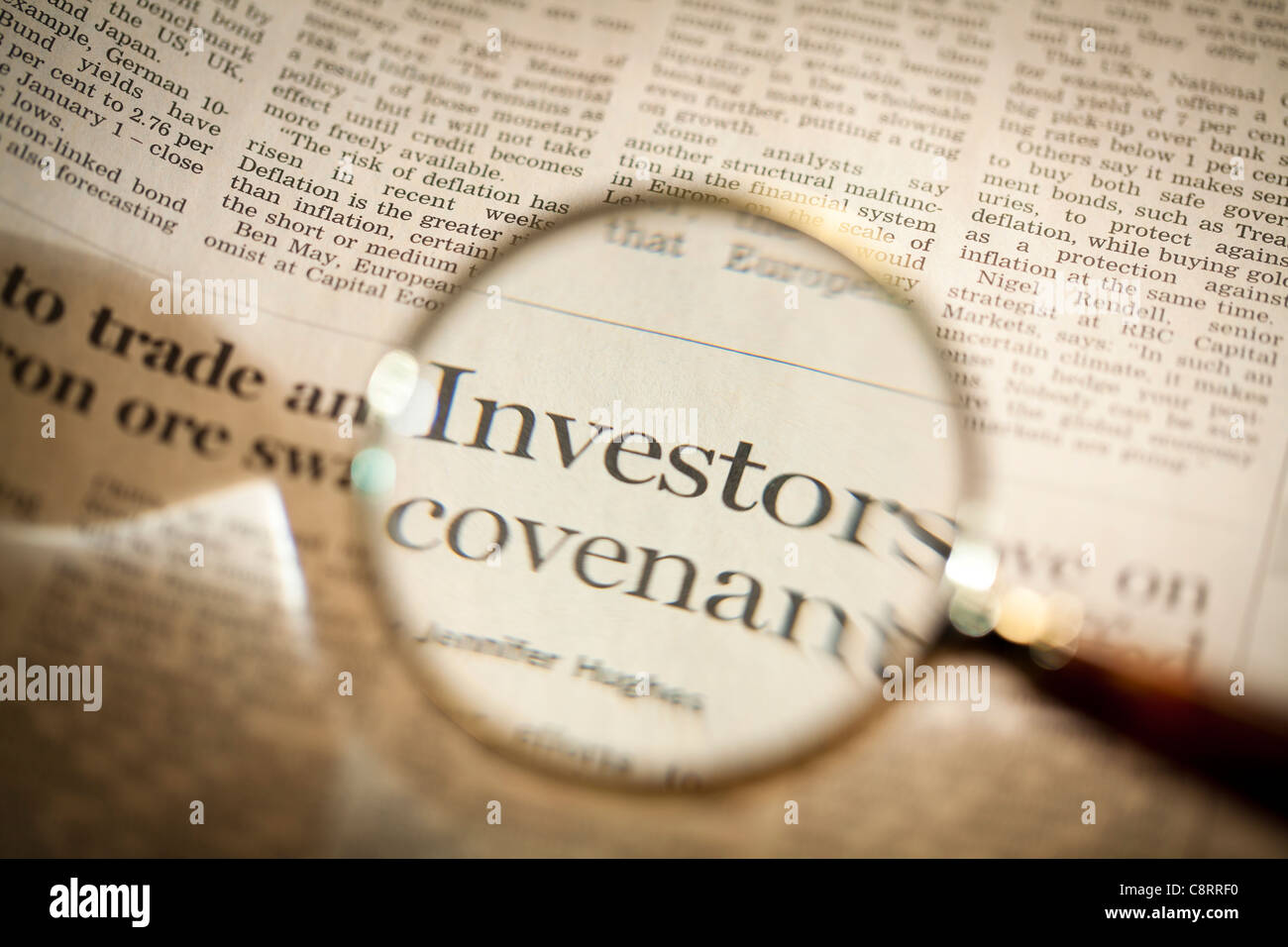 Close-up of headline of newspaper through magnifying glass Stock Photo ...