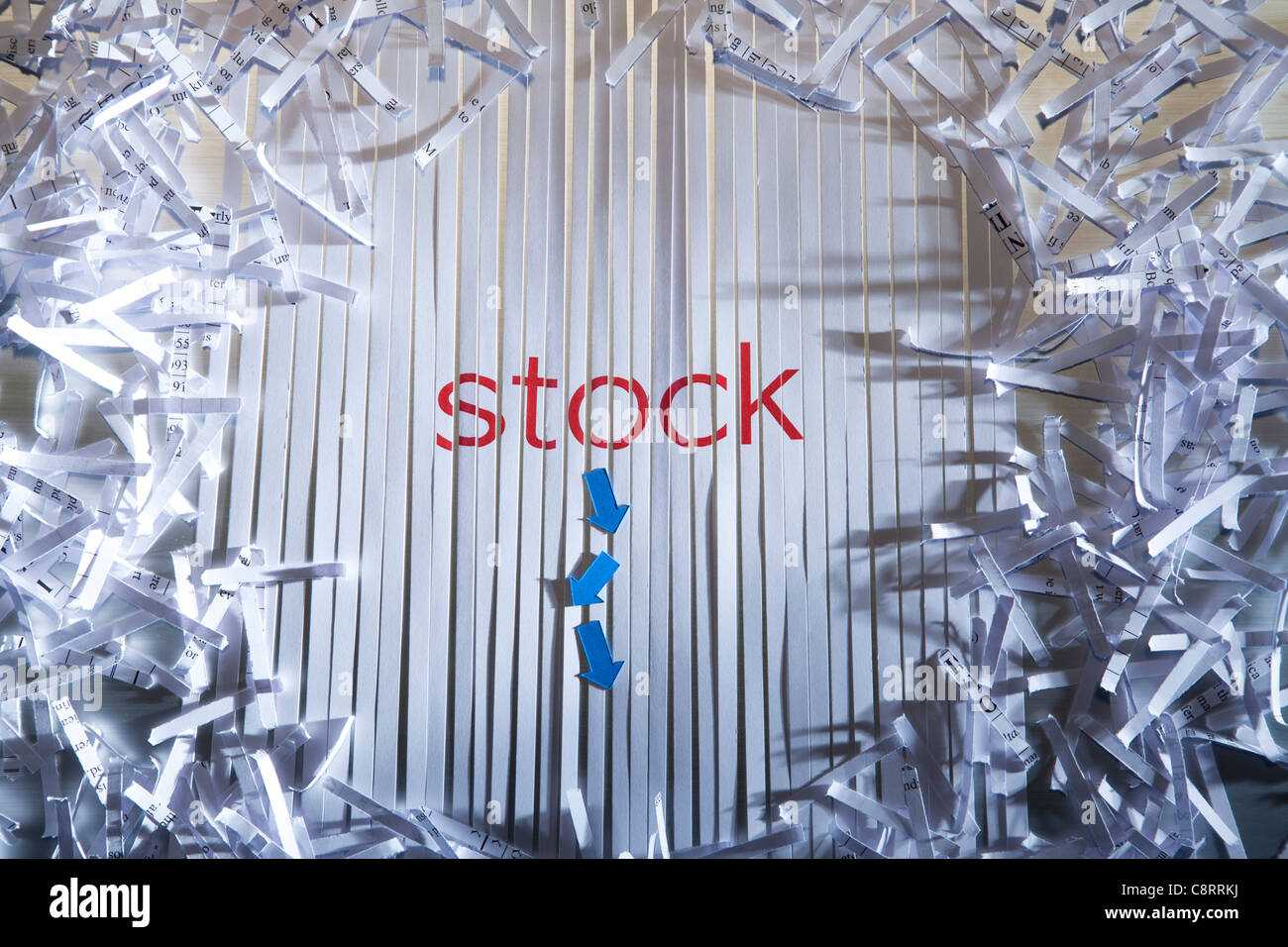 Shredded paper with text and arrow sign Stock Photo - Alamy