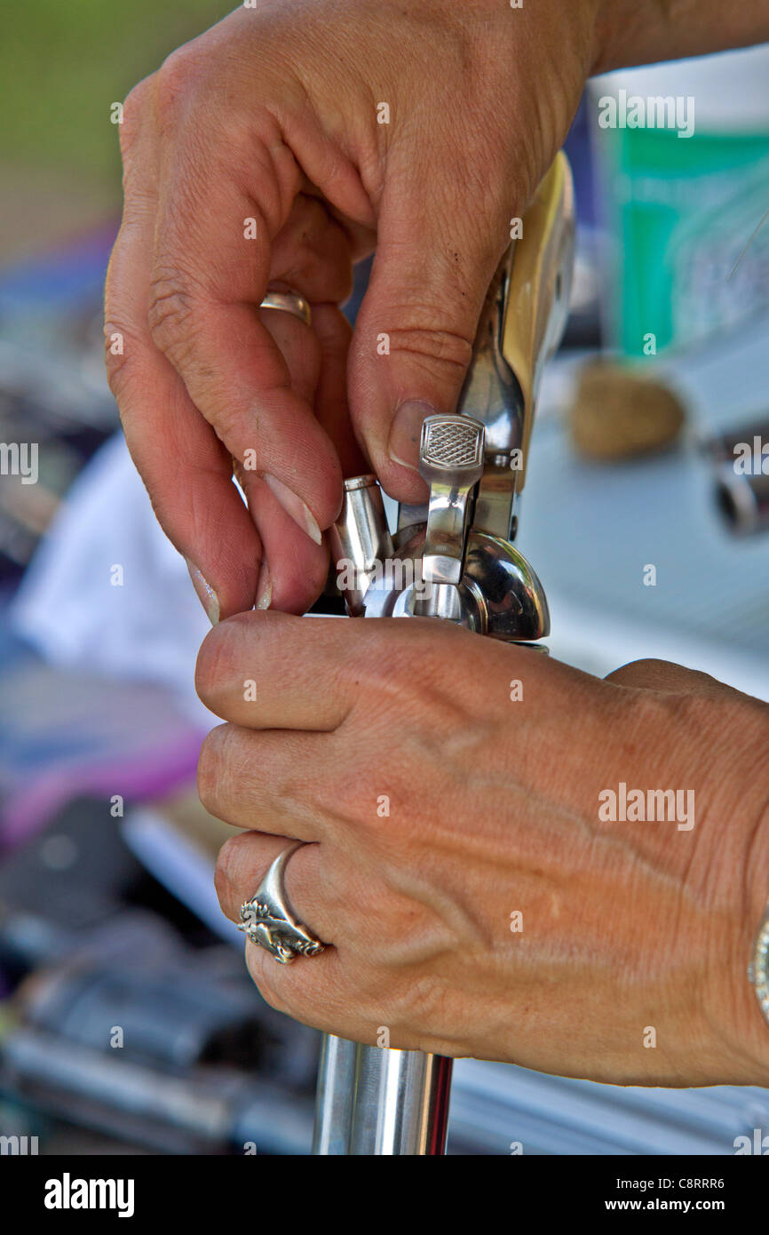 Woman loading a .45 caliber single action pistol for a Cowboy Mounted ...