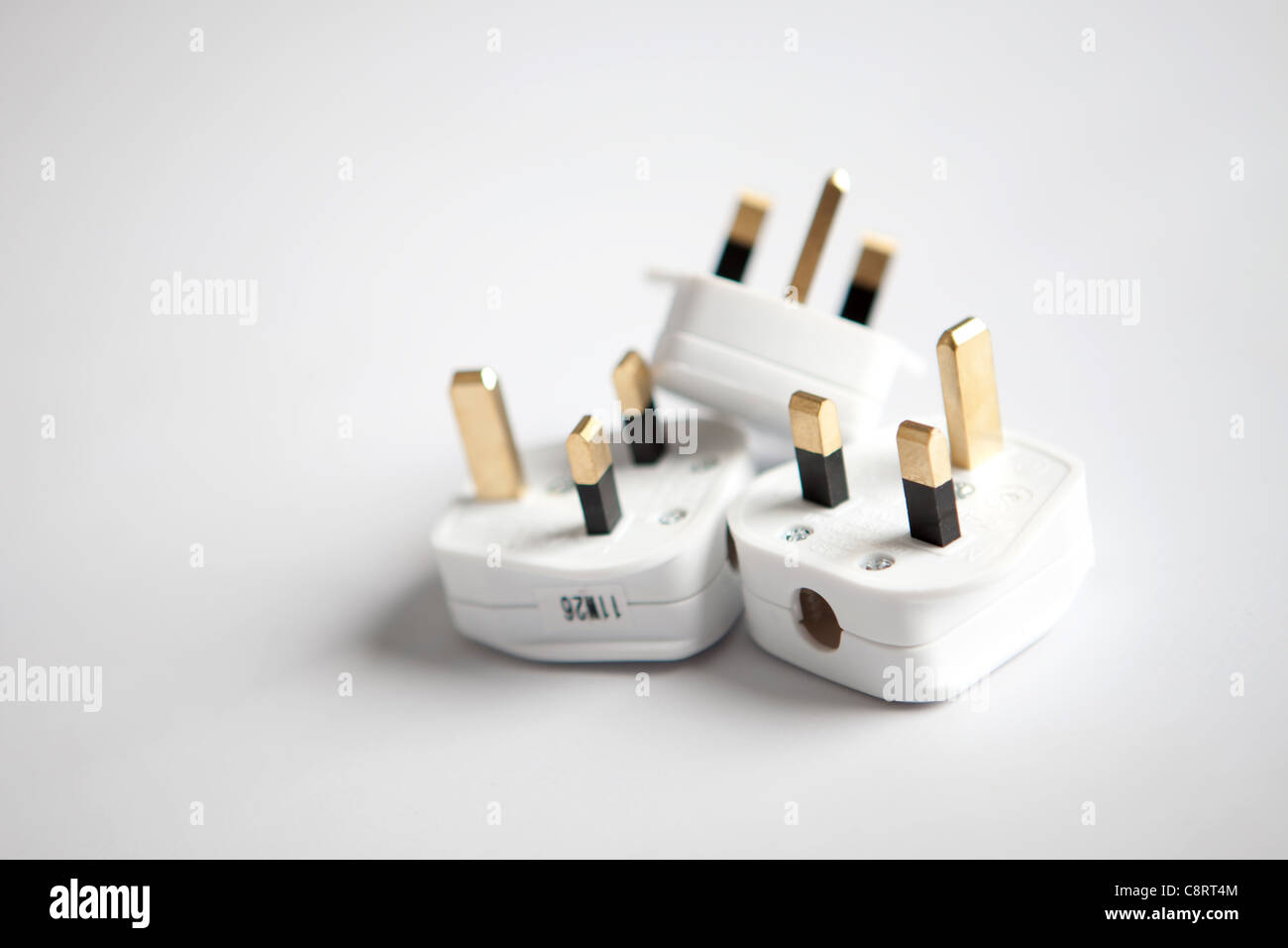 Three plugs against a white background to give a conceptual message ...