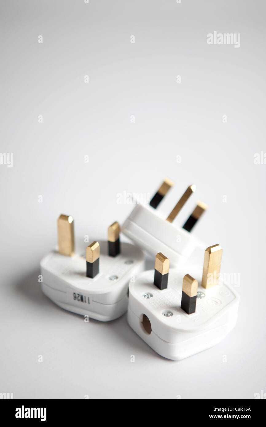 Three plugs against a white background to give a conceptual message ...