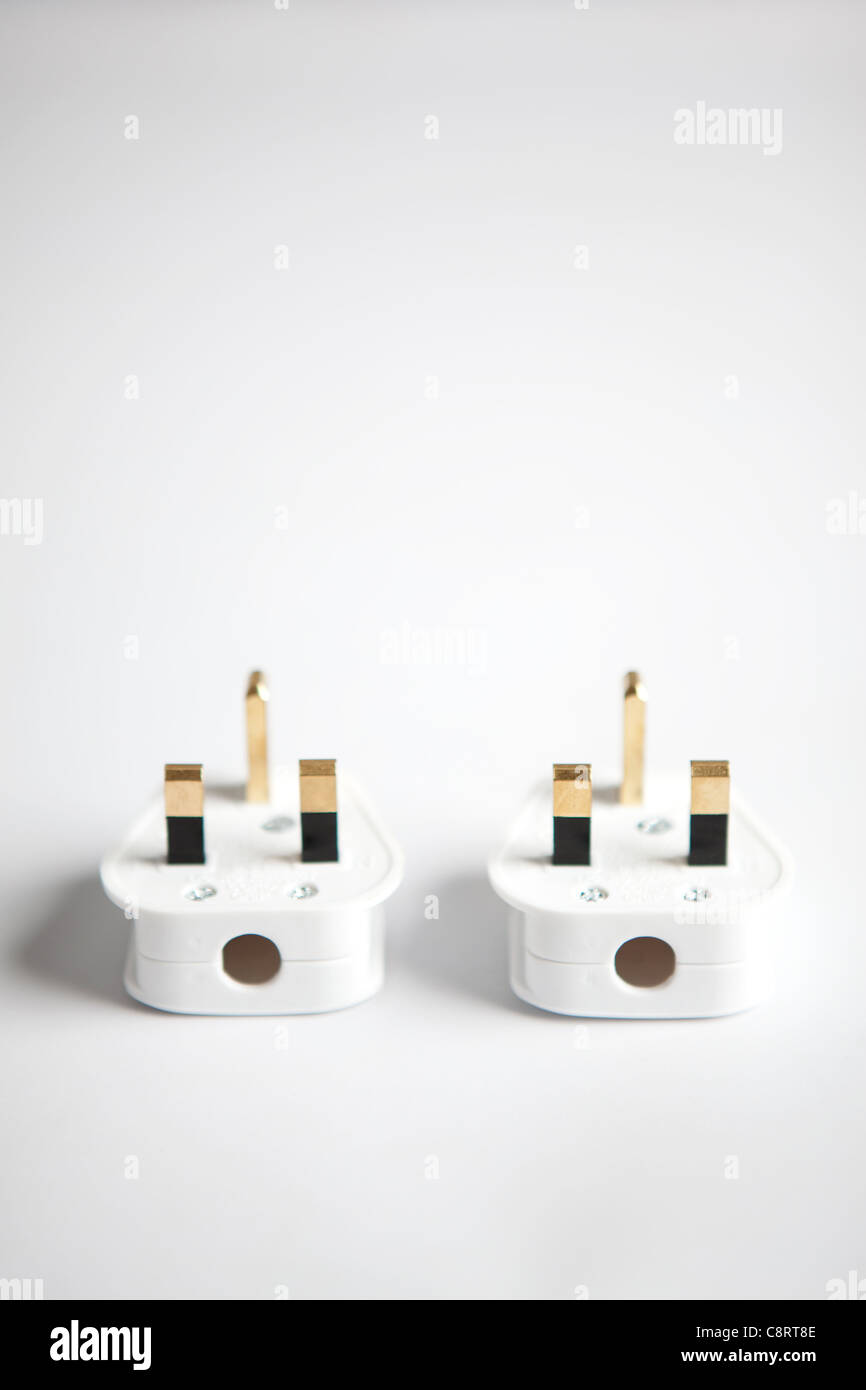 Two Plugs against a white background to give a conceptual message about ...
