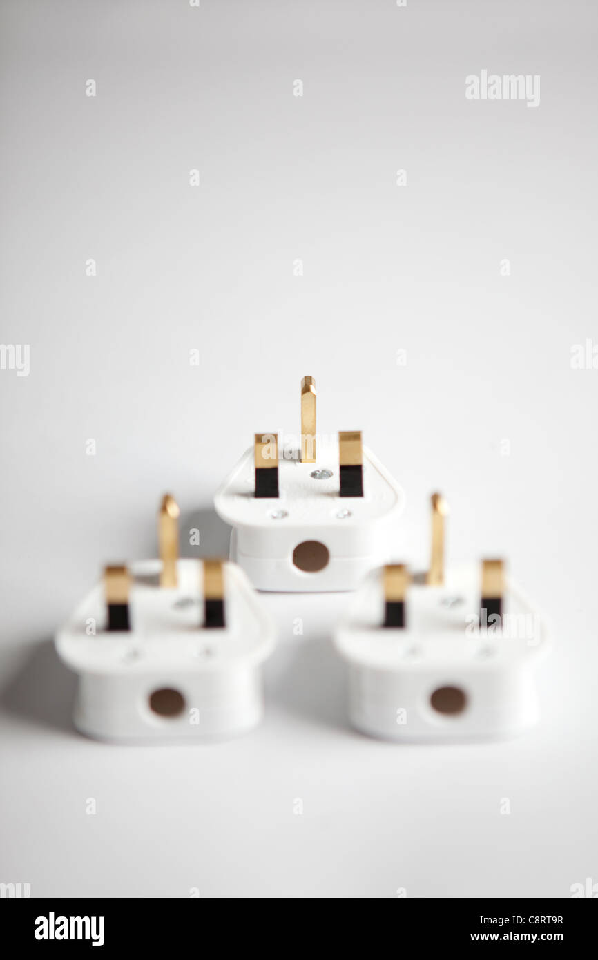 Three plugs against a white background to give a conceptual message ...
