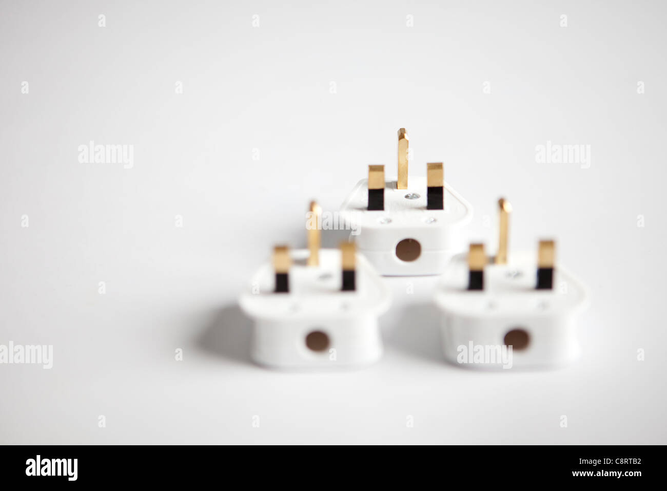 Three plugs against a white background to give a conceptual message ...