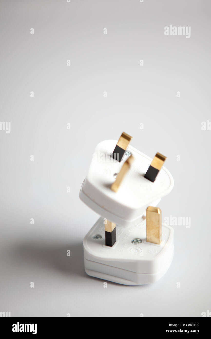 Two Plugs against a white background to give a conceptual message about ...