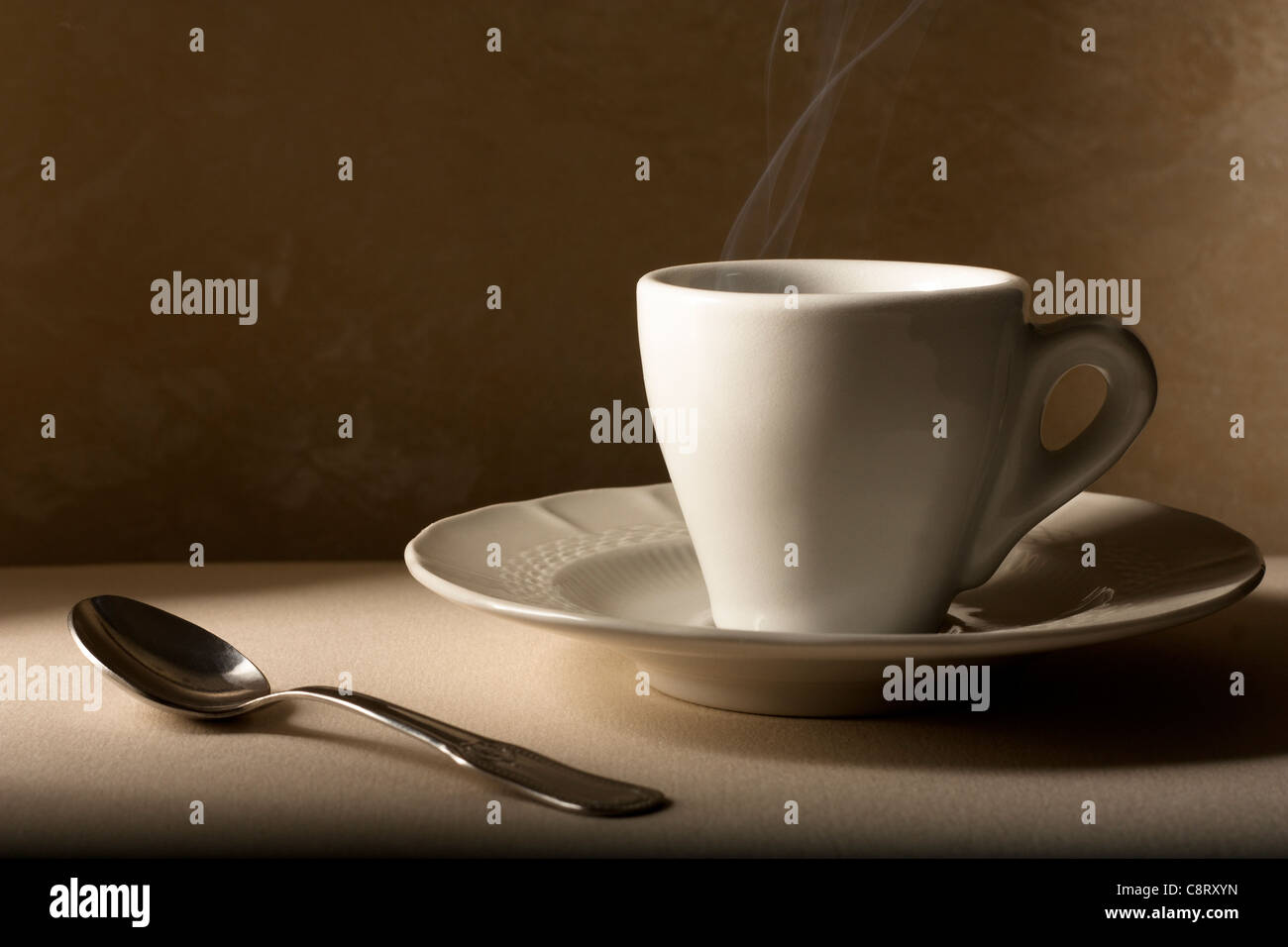 Coffee Cup with Spoon on Beige Stock Photo - Alamy