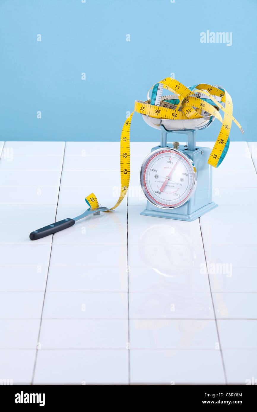 Measuring tape on weighing scale Stock Photo - Alamy