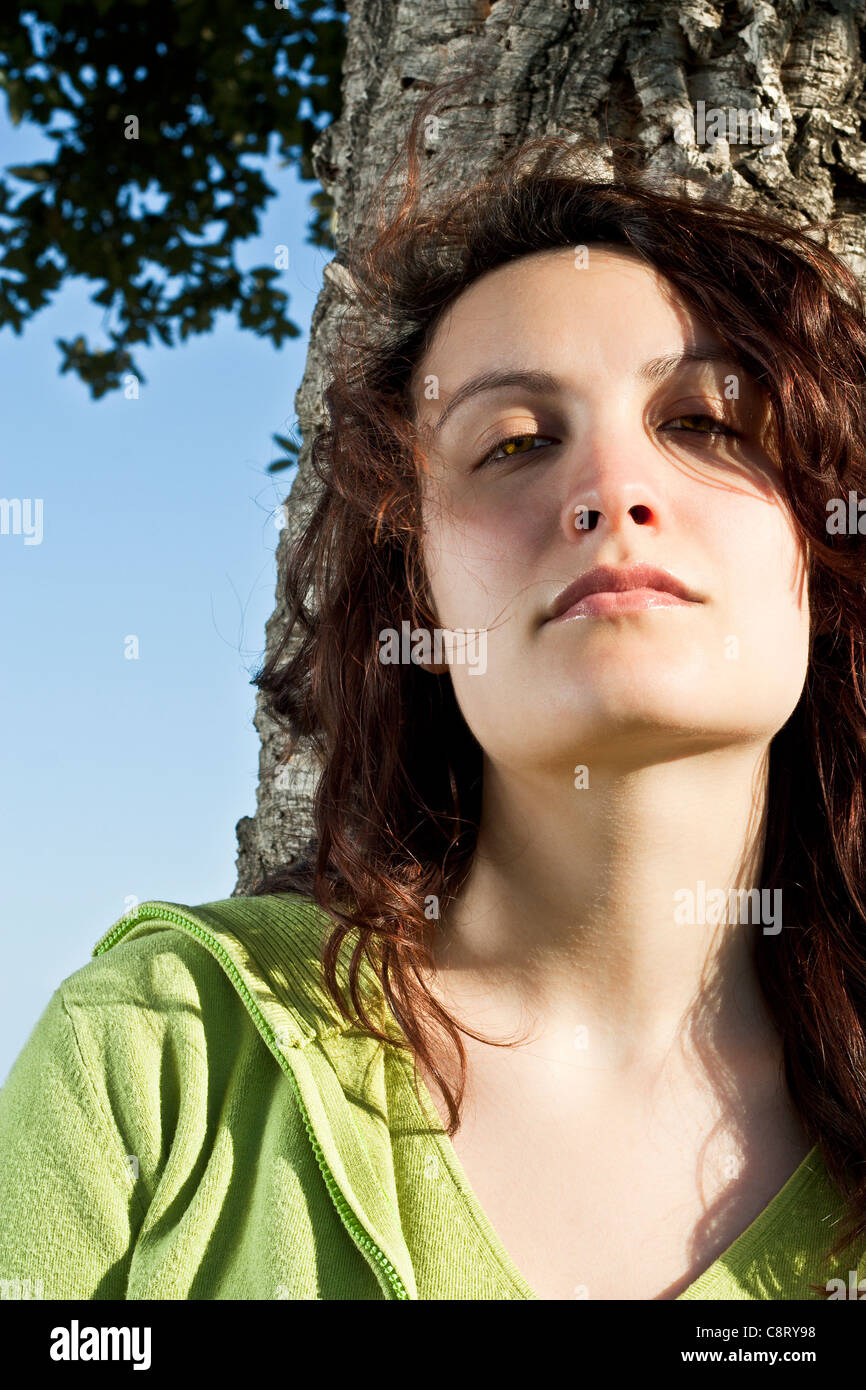 Woman Portrait with Tree Trunk Stock Photo - Alamy