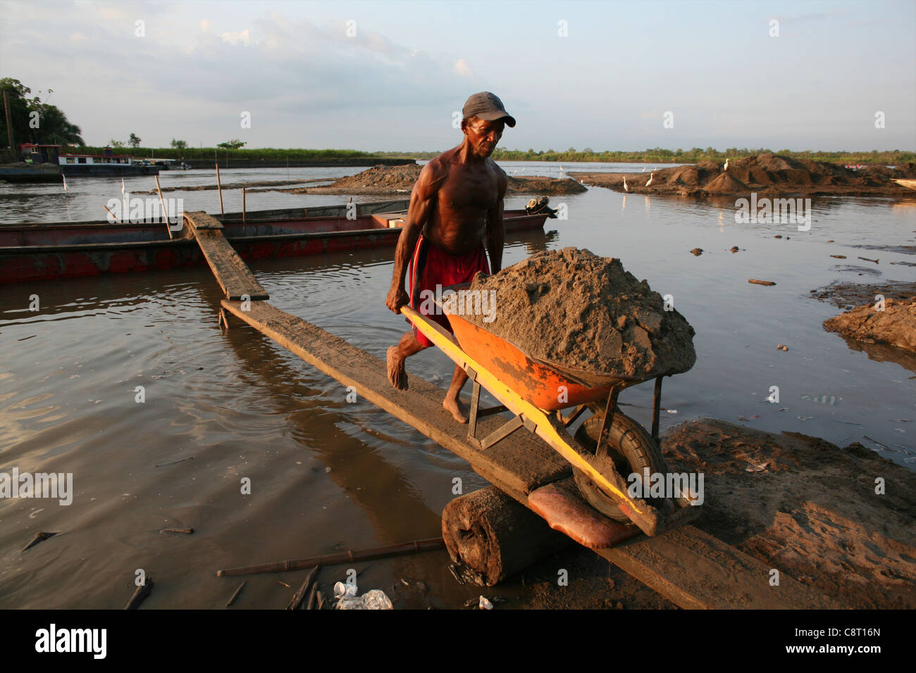 people dig sand from the bottom of the river Stock Photo - Alamy