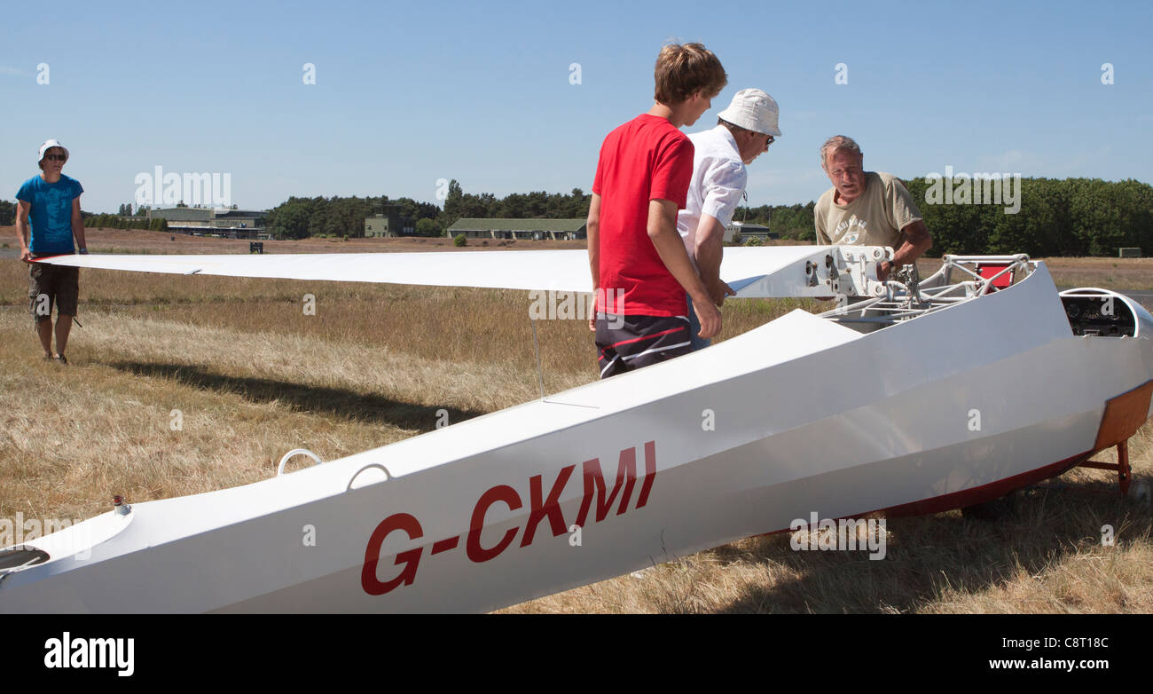 A glider is prepared for flight, having its wings attached to the ...