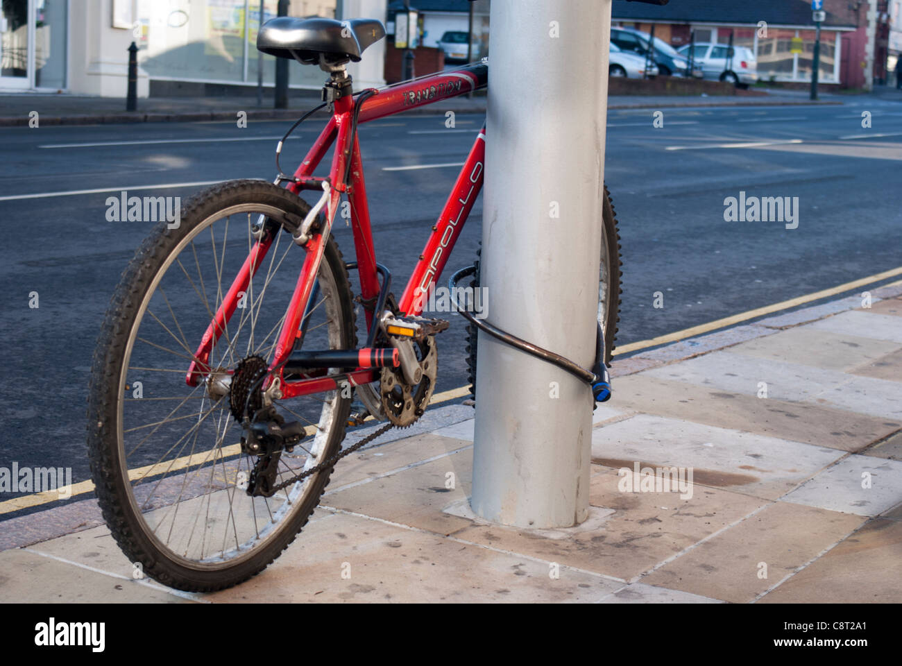 A bicycle secured to a post by a D lock Stock Photo - Alamy