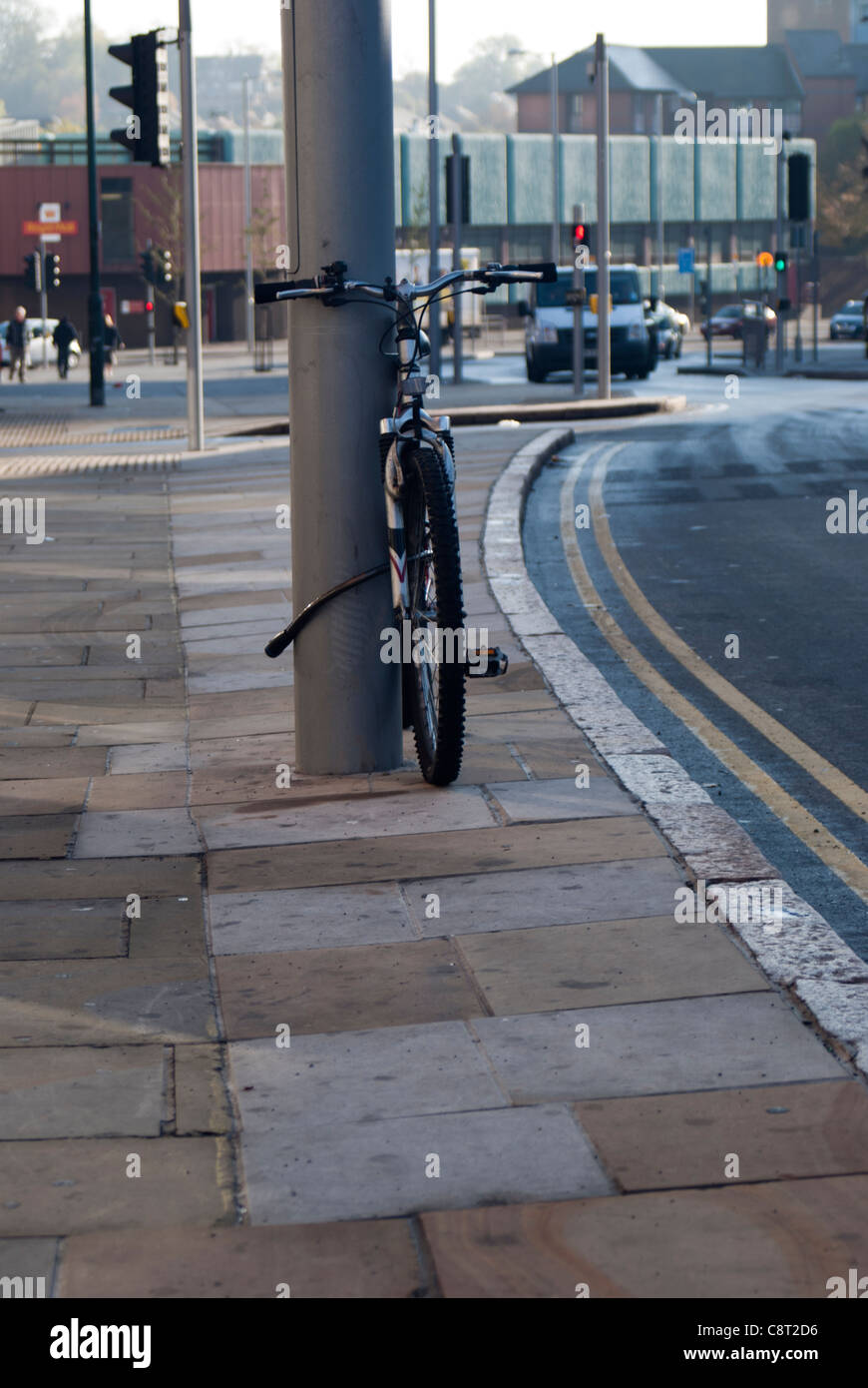 A bicycle secured to a post by a D lock Stock Photo - Alamy