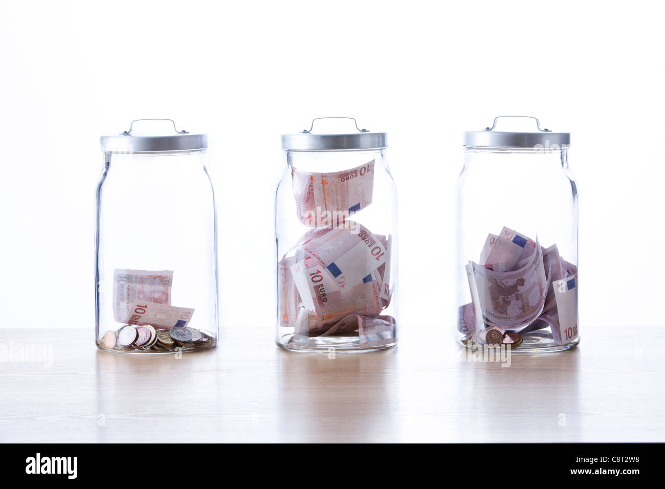 Three jars with money inside hi-res stock photography and images - Alamy
