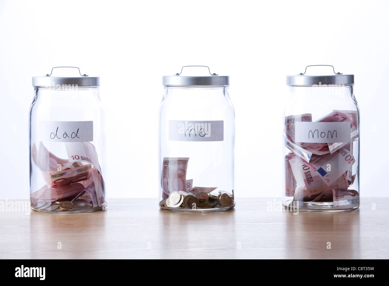 Three glass jar for labeled for family members Stock Photo - Alamy