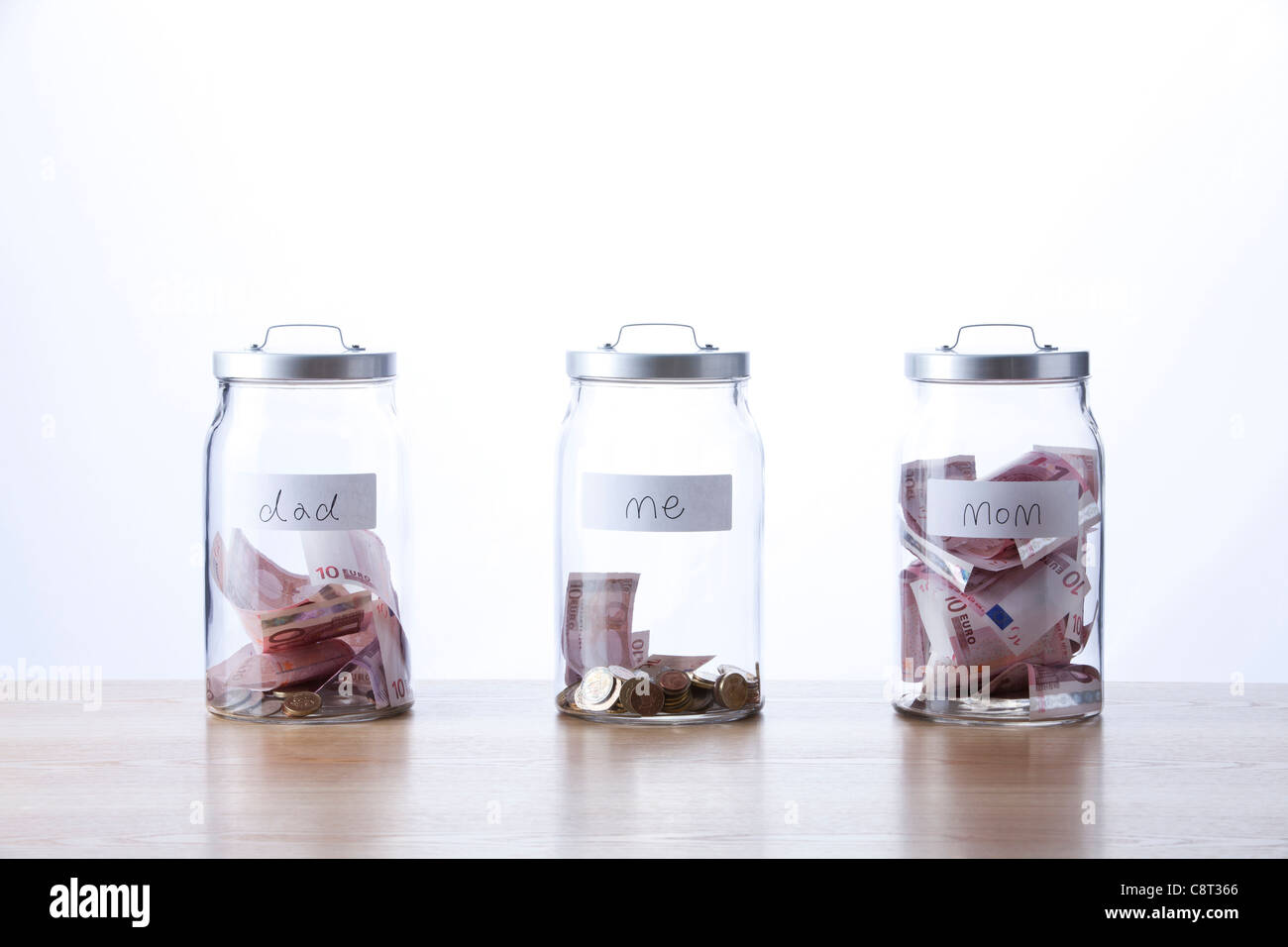 Currency Inside Three Jar Stock Photo - Alamy