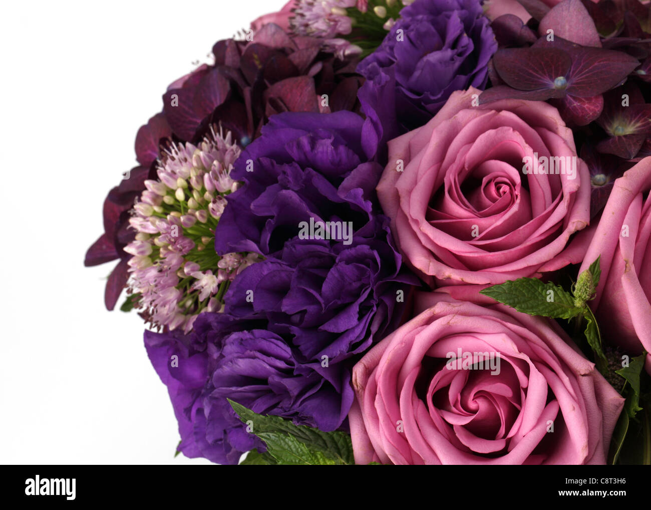 A close-up of a colorful bouquet of flowers. Pink roses, purple ...