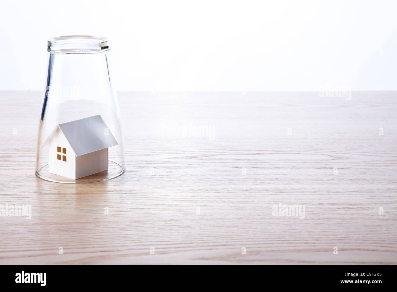 Architectural model of house inside an upside down glass Stock Photo ...