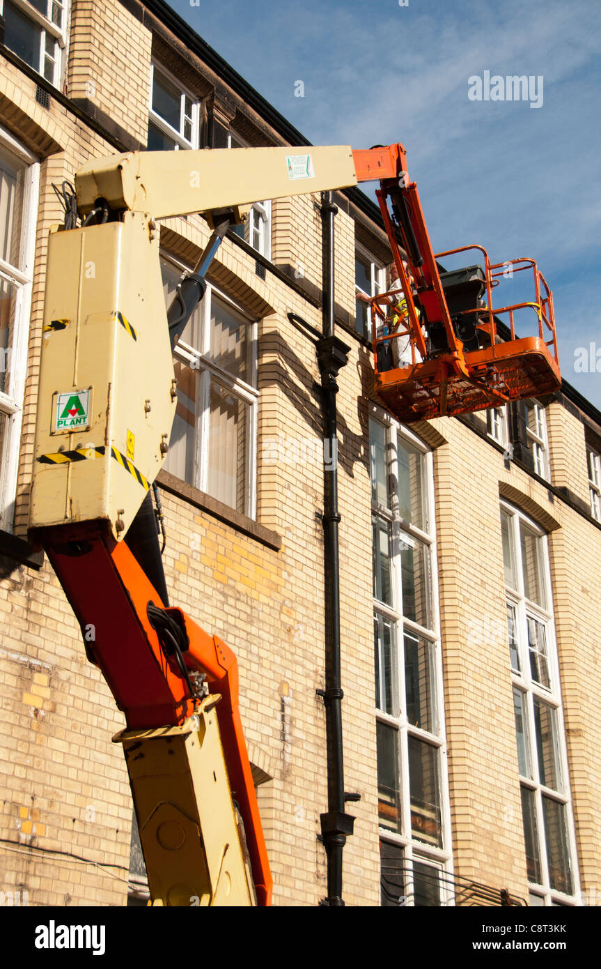 Workman on an access platform, University of Manchester, England, UK ...