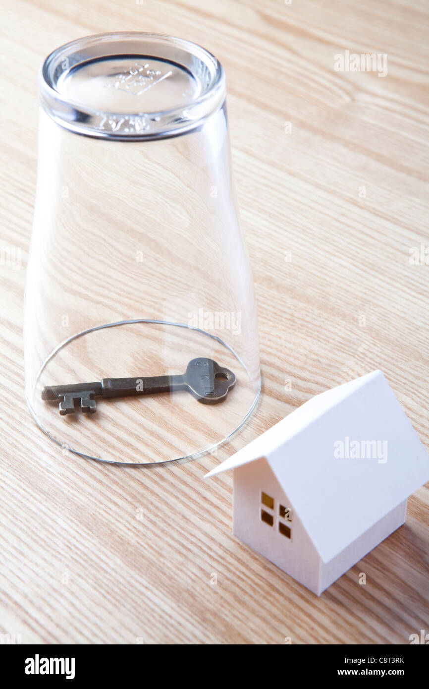 Glass With House Model And Key Stock Photo - Alamy