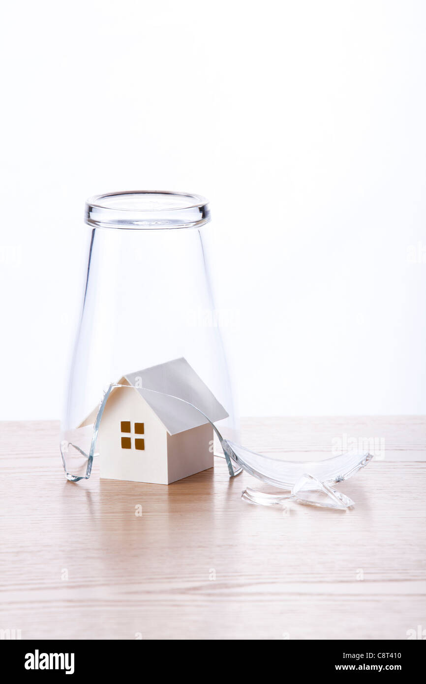Model home inside an upside down broken glass Stock Photo - Alamy