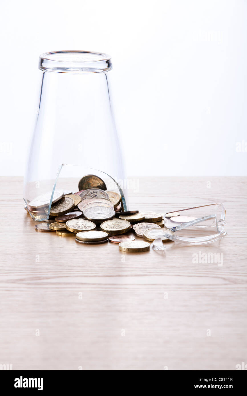 Money inside an upside down glass on table Stock Photo - Alamy