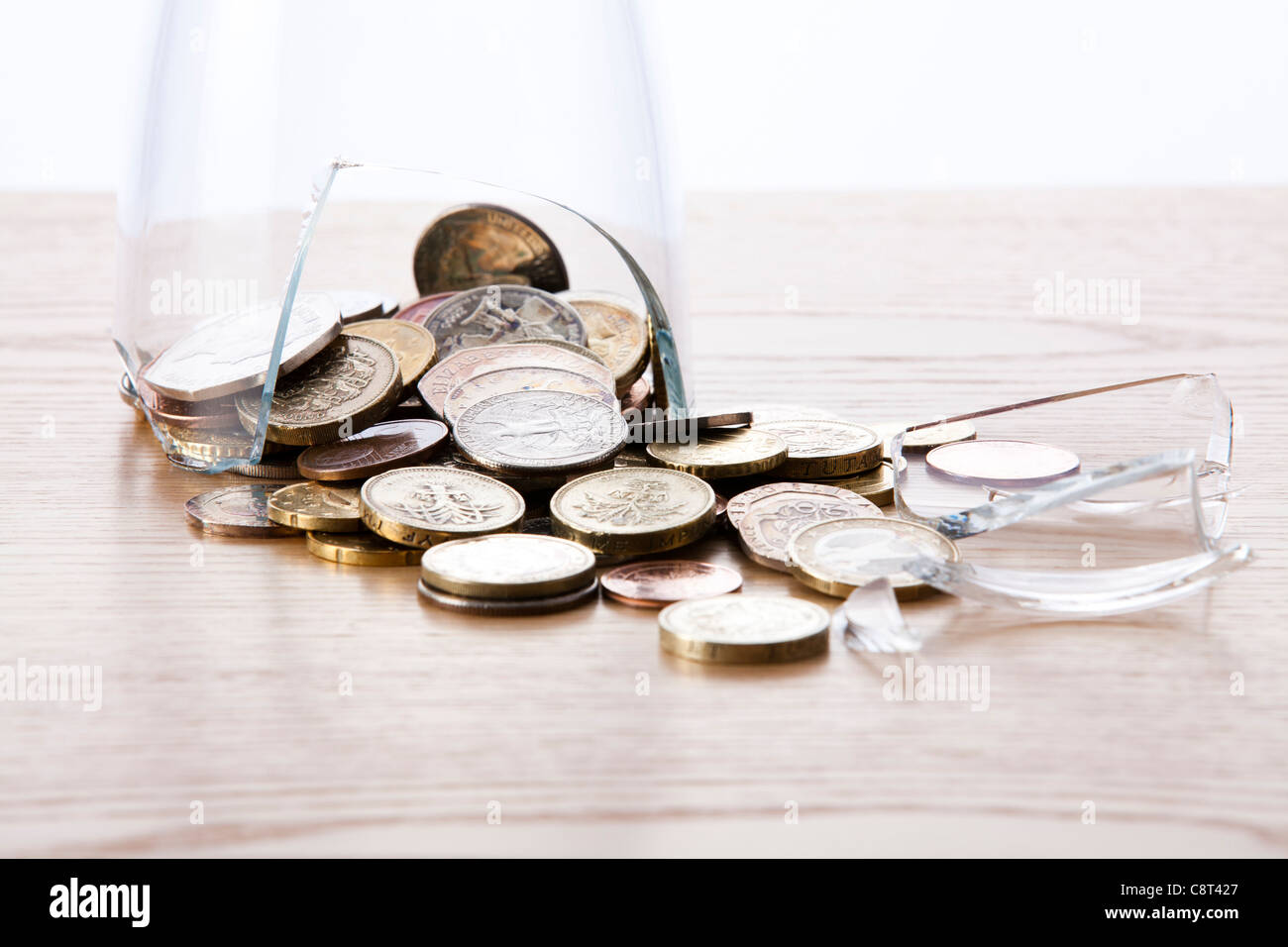 Close-up of glass upside down with money inside it Stock Photo - Alamy