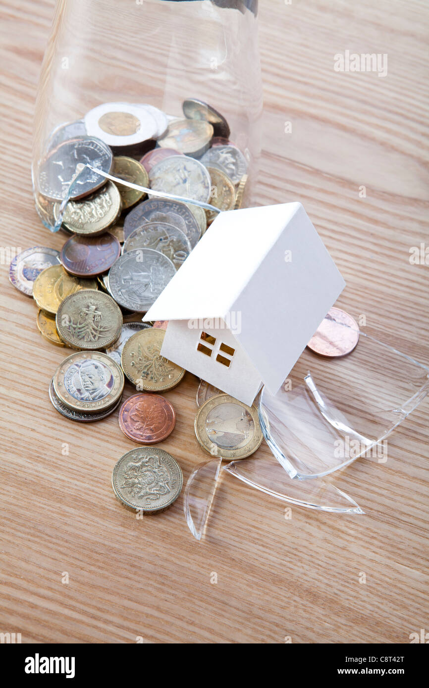 Broken Glass With Currency And House Model Stock Photo - Alamy