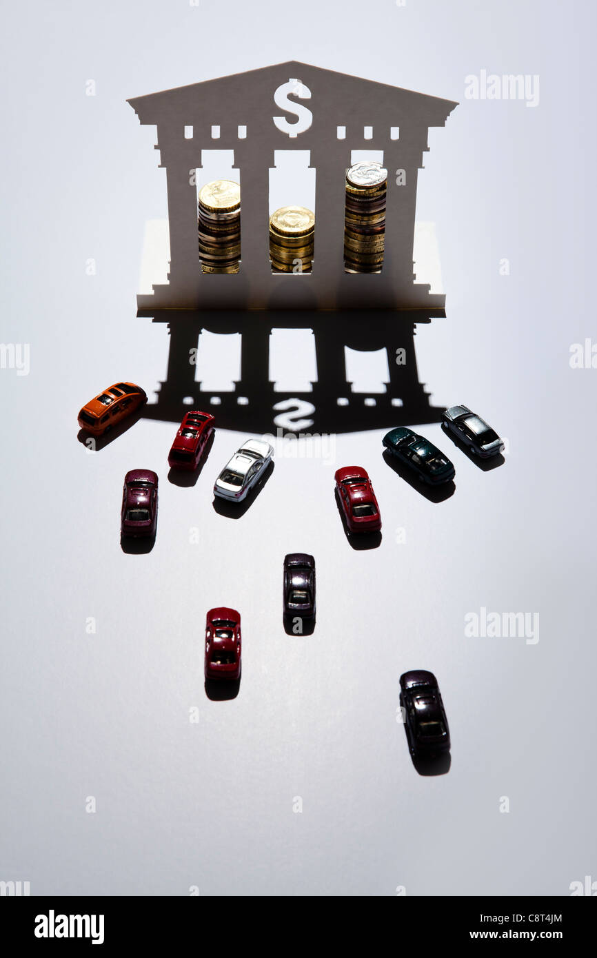 Toy cars in front of model of bank Stock Photo - Alamy