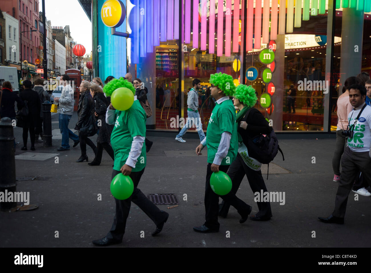 Volunteers for the cancer research charity Macmillan walk through ...