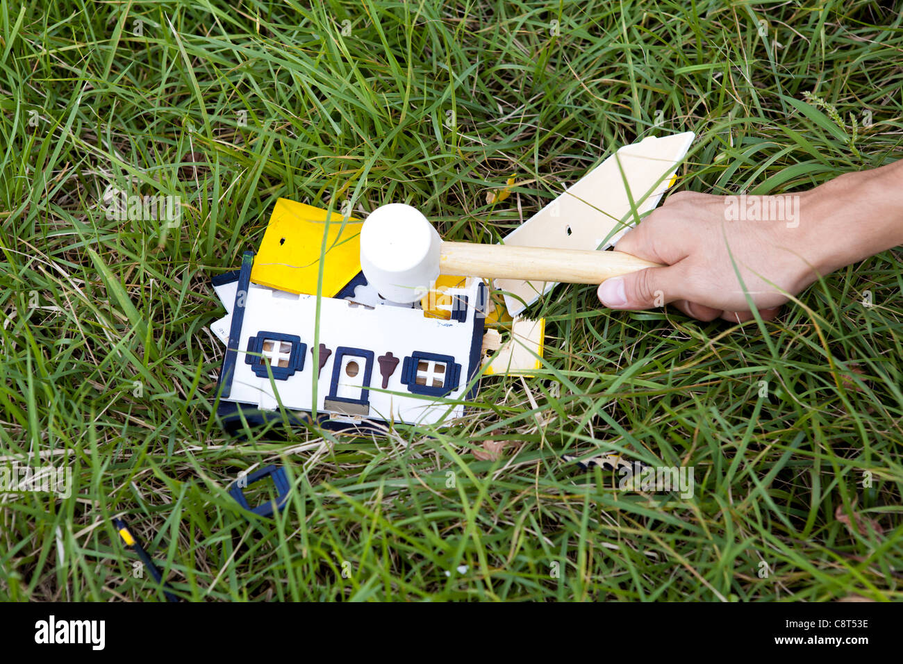 Human Hand With Hammer And House Model Stock Photo - Alamy