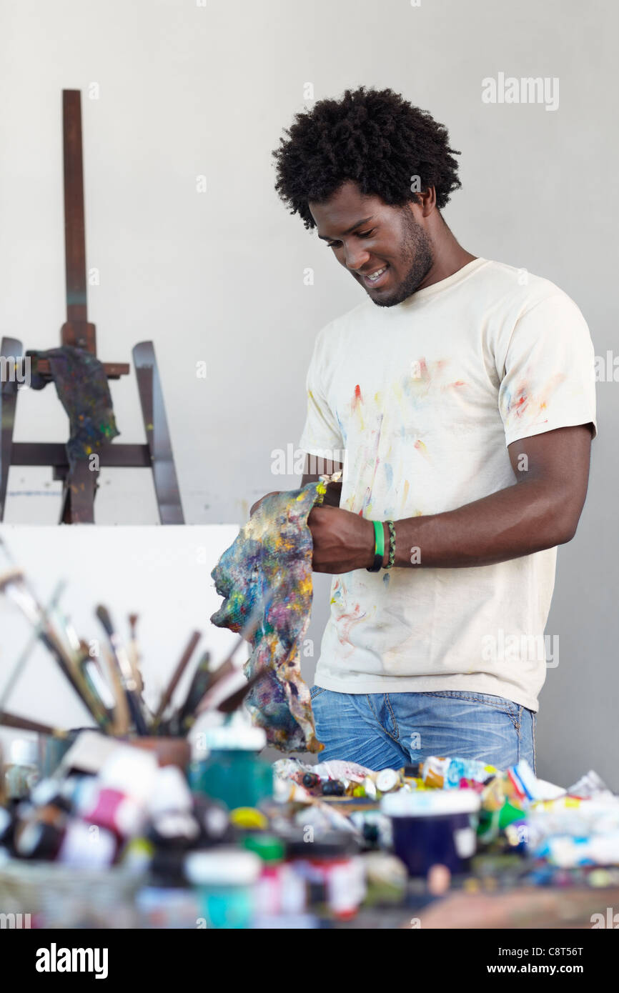 Black artist working in art studio Stock Photo - Alamy
