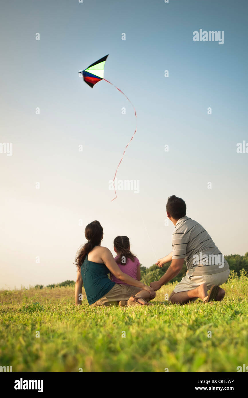 Family watching kite in sky Stock Photo - Alamy